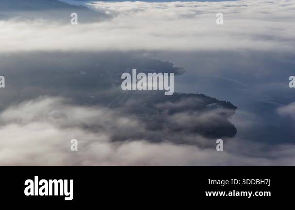 Aerial drone view of Ohrid city partially obscured by drifting fog ...