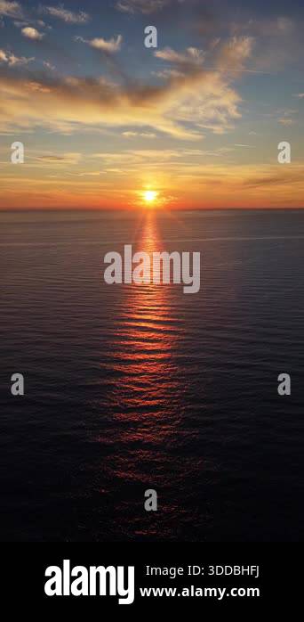 Aerial drone view of a sunset across the open Adriatic Sea, with the ...