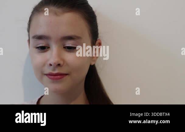 One small beautiful happy brunette Caucasian girl holds a stick with an ...