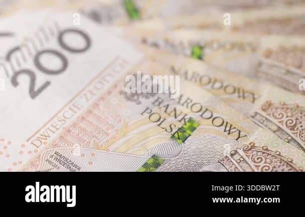 A rotating macro view of several two hundred zloty banknotes arranged ...