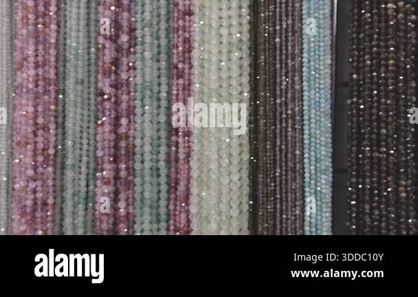 Beautiful natural stones arranged on hanging strings form tidy lines ...