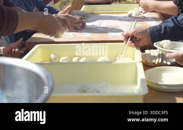 Rolling freshly pounded rice cakes Stock Video Footage - Alamy