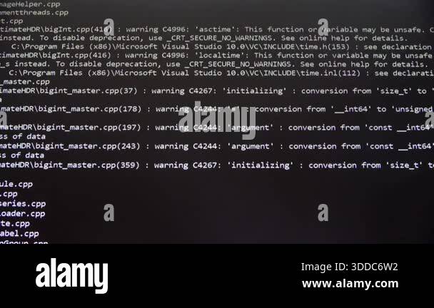 White programming code scrolling on a black screen while compiling a ...