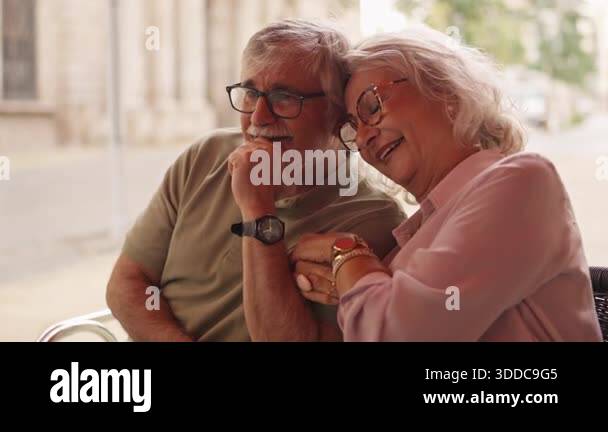 Happy senior couple enjoying their time together at an outdoor cafe ...