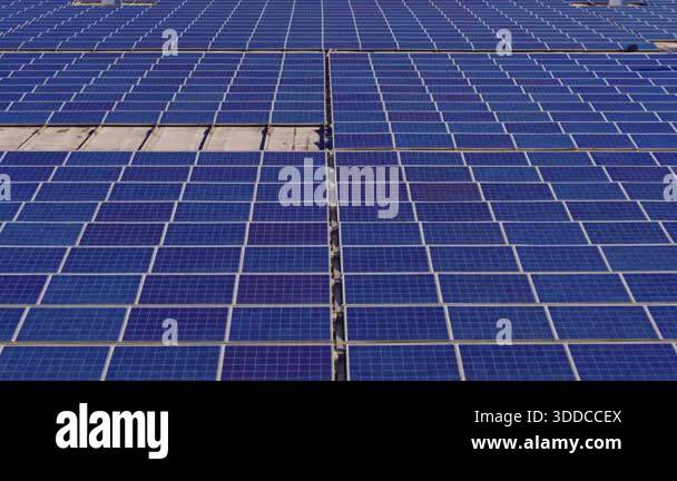 Endless rows of photovoltaic solar panels at a power plant producing ...