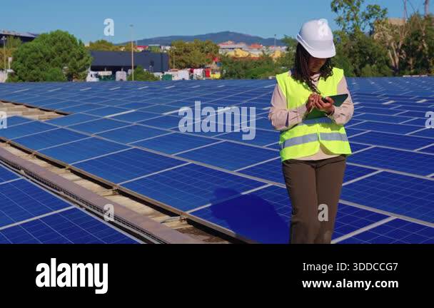 Professional woman engineer in a hard hat and safety vest working on a ...