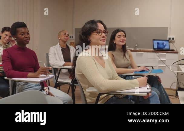 Multiethnic group of female students attending a class in a university ...