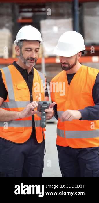 Experienced manager training a young employee on using a barcode ...