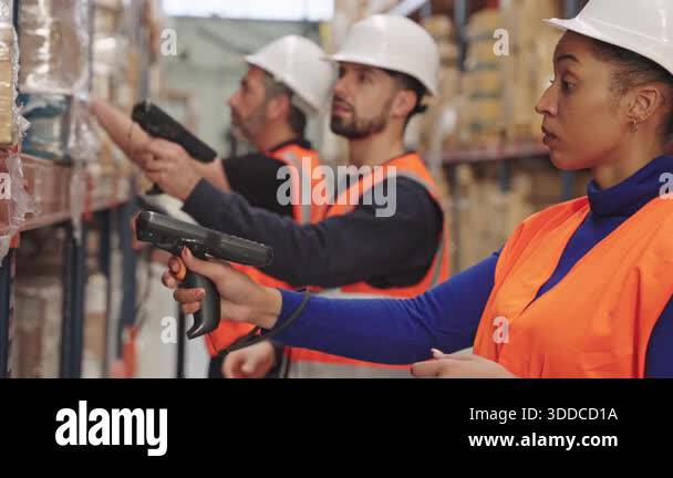 Diverse team of employees in a storage depot scanning merchandise on ...