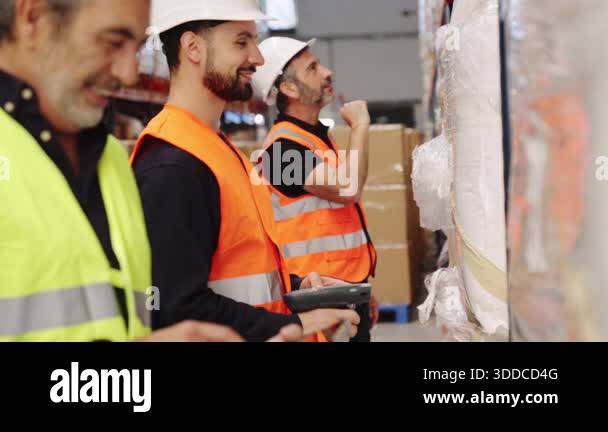 Logistics team working together in a distribution center. Manager ...