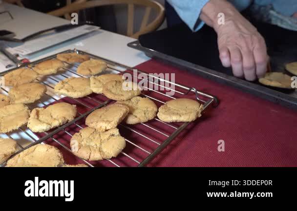 Stockholm, Sweden A cook rolls butter cookies onto an oven tray Stock ...