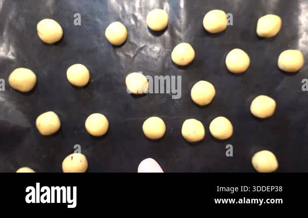 Stockholm, Sweden A cook rolls butter cookies onto an oven tray Stock ...