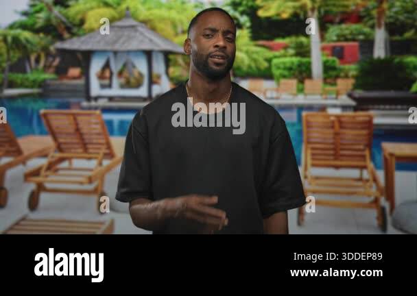 Man clutching chest with hand on sternum at resort pool beside hotel ...