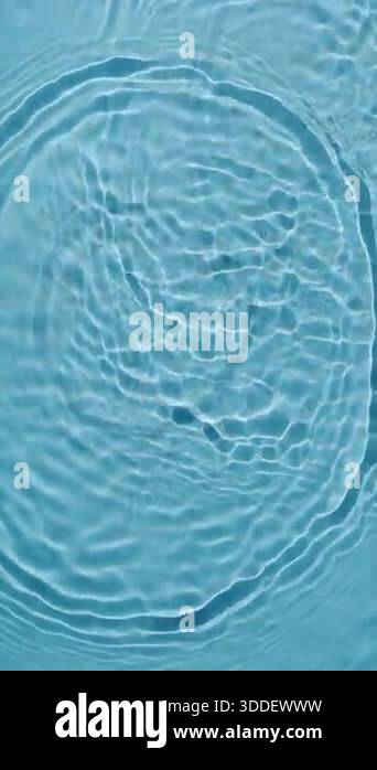 Blue water ripples with light reflections in a swimming pool or clear ...