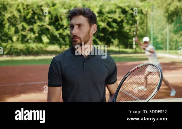 Handsome young tennis player man look at camera smiling on outdoor ...