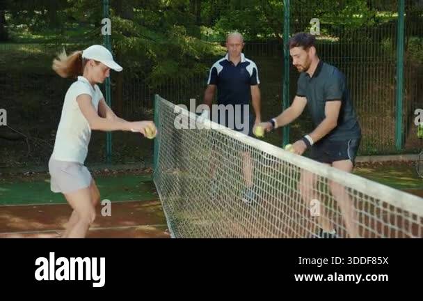 Close up coaching teaching play tennis man and woman on a court outdoor ...