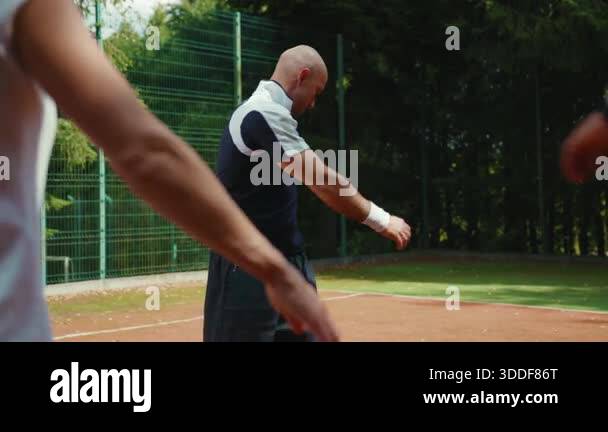 Close up players warm up before a game of tennis with trainer success ...