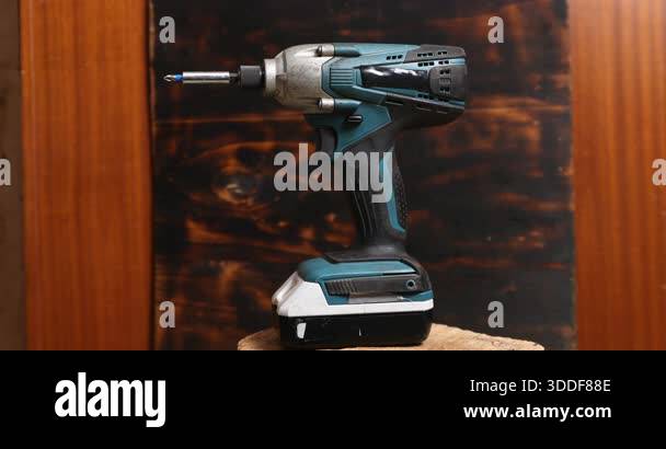 Cordless Electric Impact Driver Power Tool on a Wooden Background Stock ...