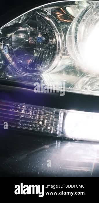 Close-up of a car headlight shining brightly at night, showcasing ...