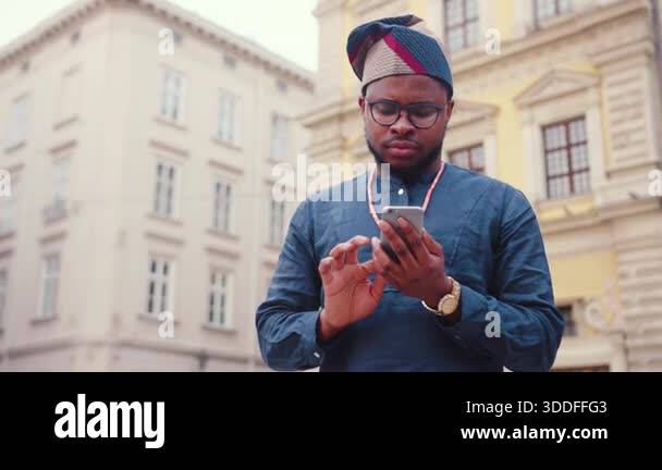 In an urban environment, a young man dressed in traditional attire is ...