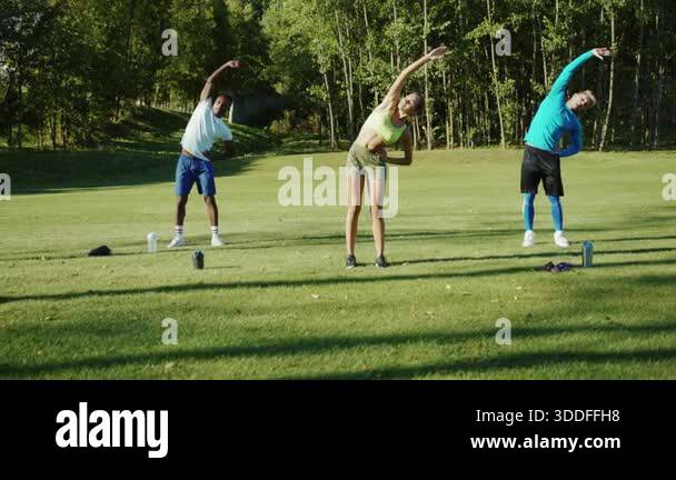 Three multi-ethnic athletic friends doing aerobics energetic exercises ...