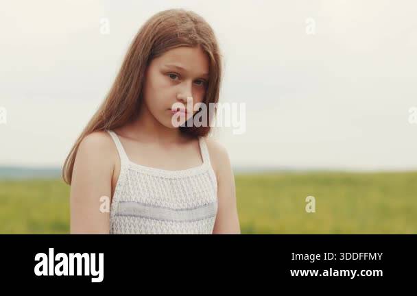 Cutie with pleasant smile looking into camera. Footage of nice teenage ...