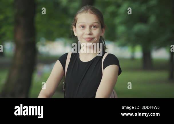 Shooting of good-looking young Caucasian girl looking directly into ...