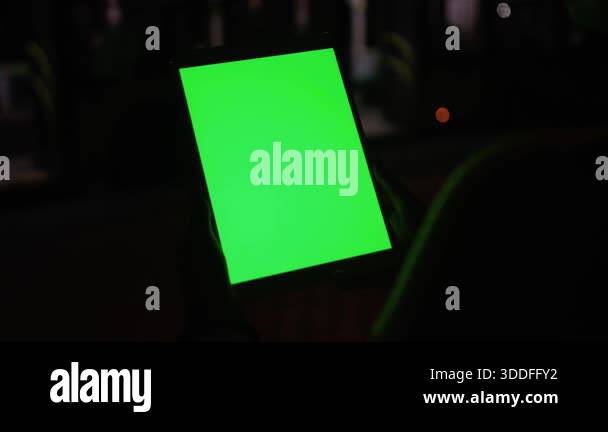 Close-up of person holding vertical modern tablet computer in hands ...