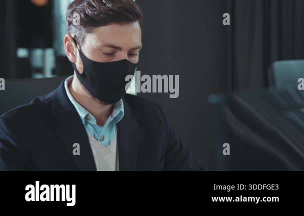 Close up man wear mask work use computer in modern office business ...