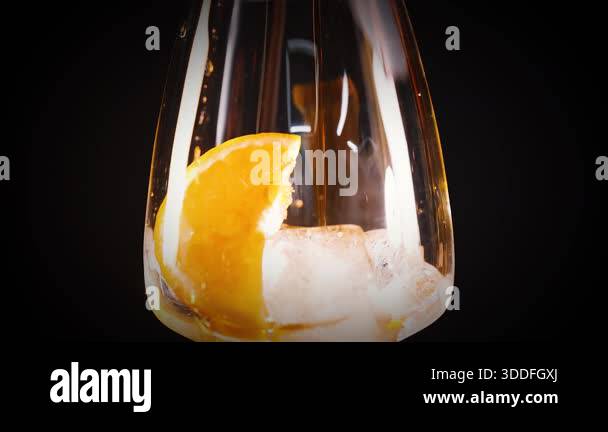 Orange slice in glass with ice and liquid Stock Video Footage - Alamy