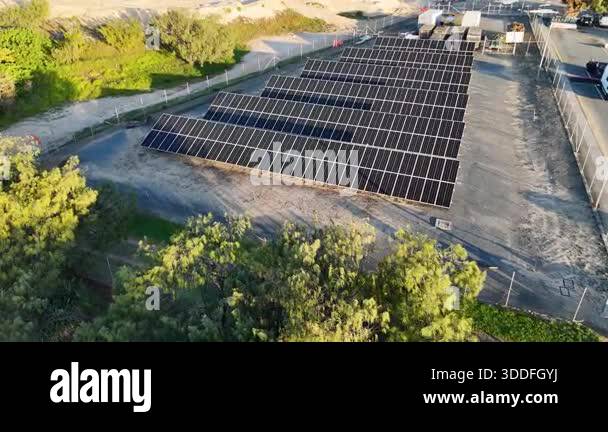 Aerial footage of solar panels on sandy terrain, captured in bright ...