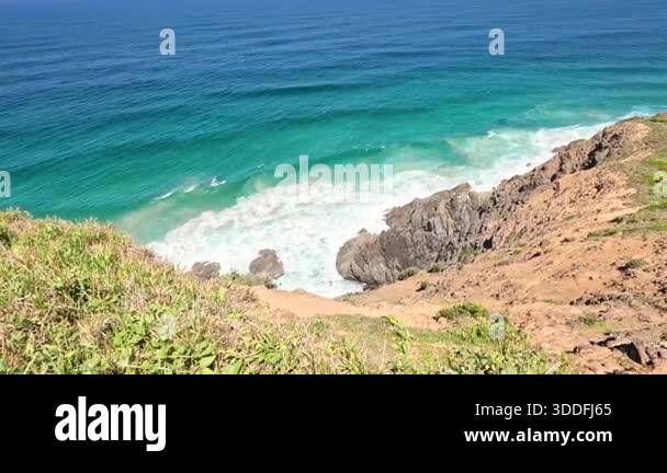 Aerial view of waves hitting a rocky shore Stock Video Footage - Alamy