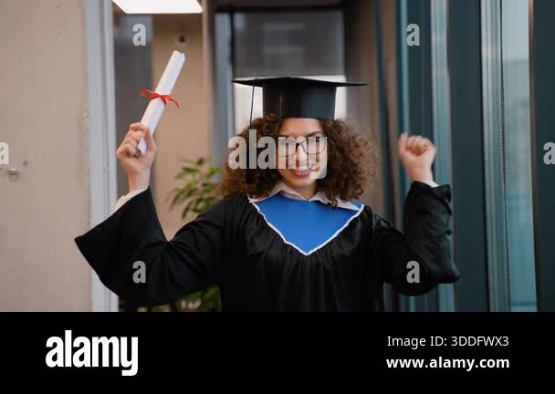 Portrait of a joyful university graduate holding her diploma. The young ...