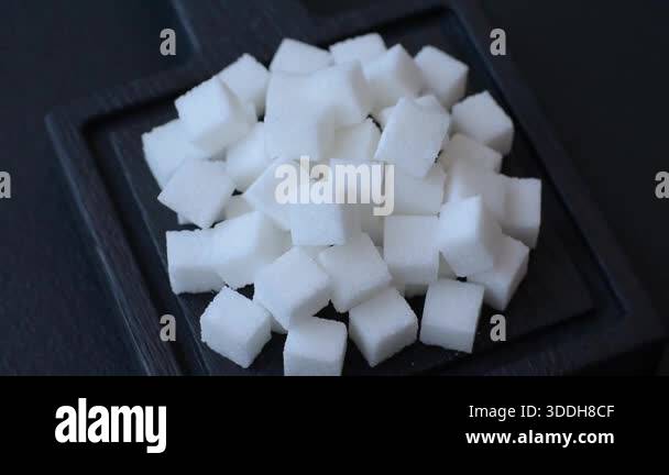 Sweet white sugar cubes as a source of glucose. White sugar cubes as a ...
