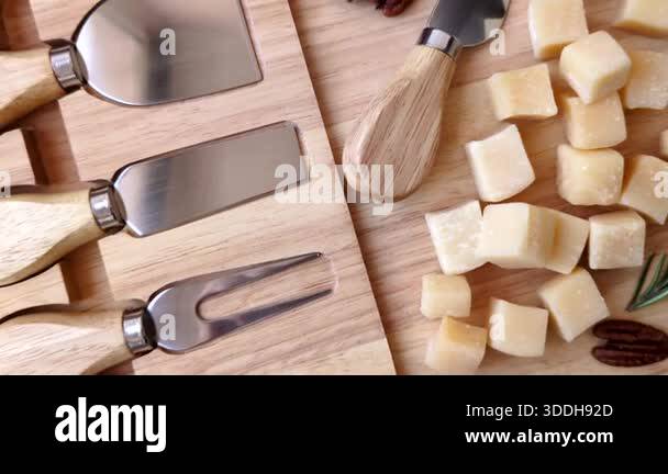 Cubed cheddar, gouda, or parmesan cheese on a cutting board. Cubed ...