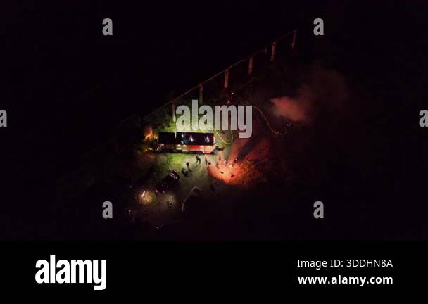 Aerial drone shot filming burning car fire and firefighters at work ...