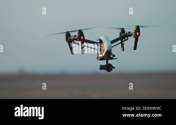 Drone copter flying above farming fields, scanning wheat fields for ...
