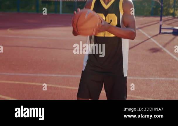 Front view of good-looking African man in sportswear holding ball in ...
