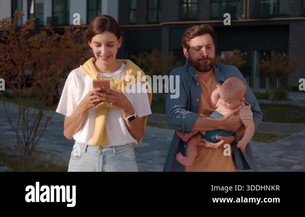 Young parents take turns looking after child. Funny father trying to ...