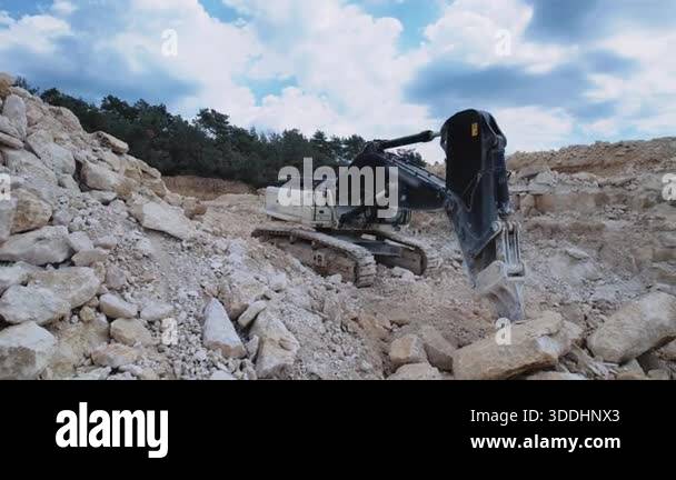 Drone footage of black crawler excavator working on quarry. Mining ...