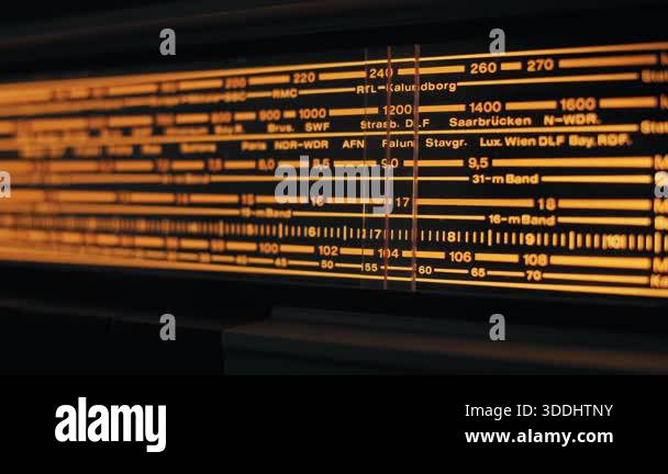 Extreme close-up of a tuning needle moving across an illuminated radio ...