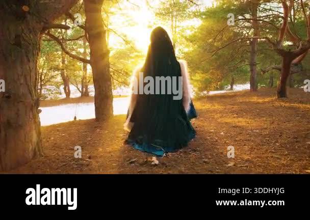 Fantasy woman walks in winter forest. Princess girl. Green long vintage ...