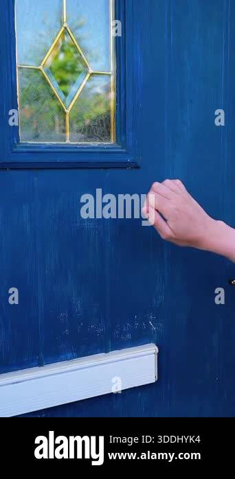 A teenager knocking on the door from the front of the house, close-up ...