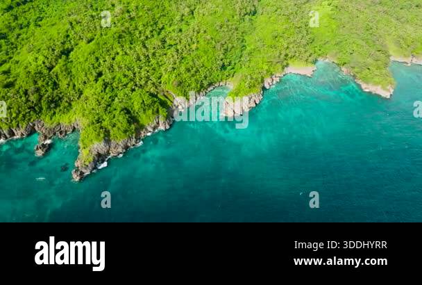 Transparent turquoise sea water and waves splashing on coastline rocks ...