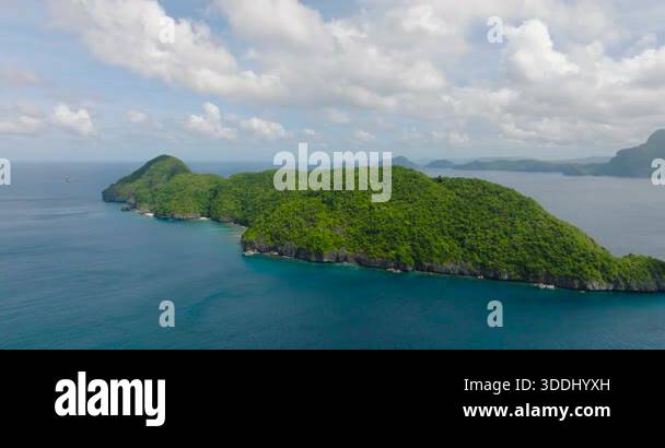 Tropical Island with blue sea and cliffs. Inambuyod Island. El Nido ...