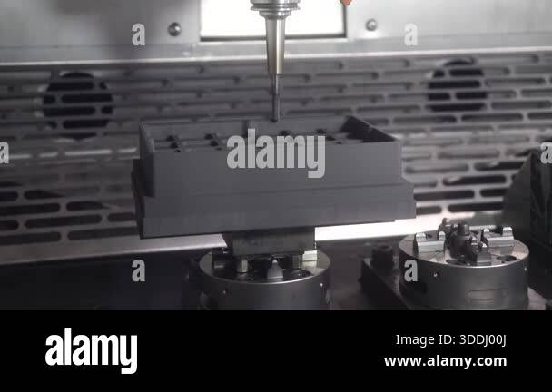 The CNC milling machine cutting the graphite electrode parts with solid ...