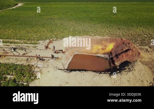 View from above of pit filled with water. Fire. Checking operation of ...