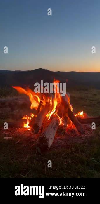 Close up of warm campfire on background mountains at night. Beautiful ...