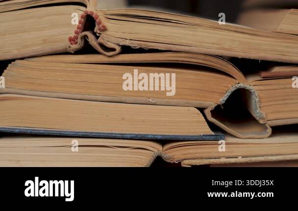 Stacked antique volumes showing worn pages and bindings in archival ...