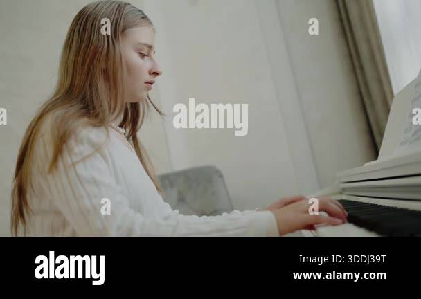 Teenage girl practicing piano at home. Study and learning development ...